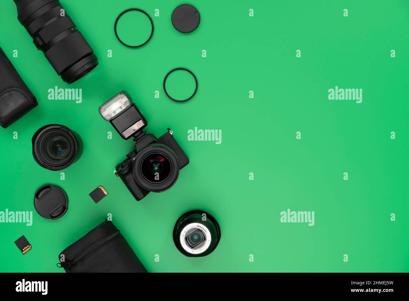 Green background table with some photography props Stock Photo - Alamy