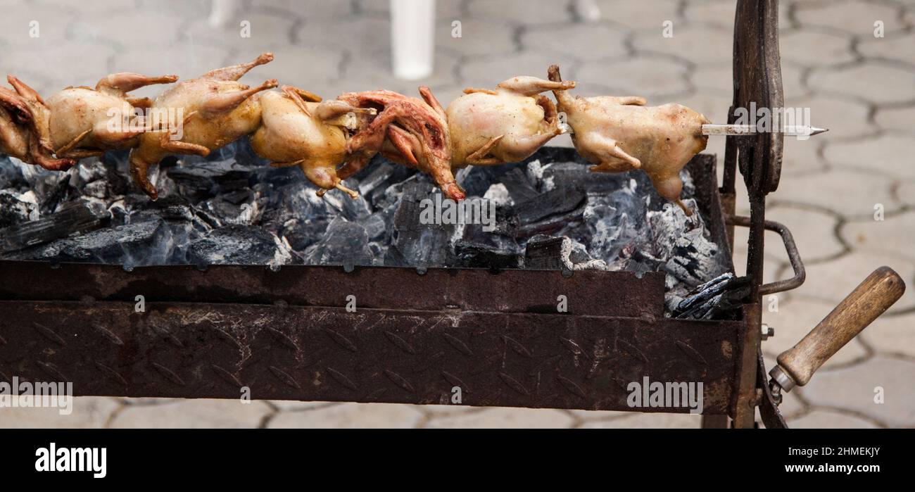 Quails strung on a skewer and grilled in barbecue Stock Photo - Alamy