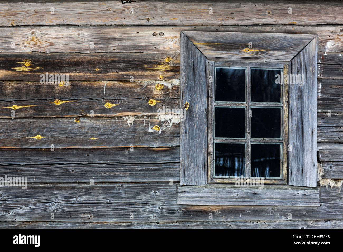 Rustic wooden house made of round logs. Wooden window frame Snow ...