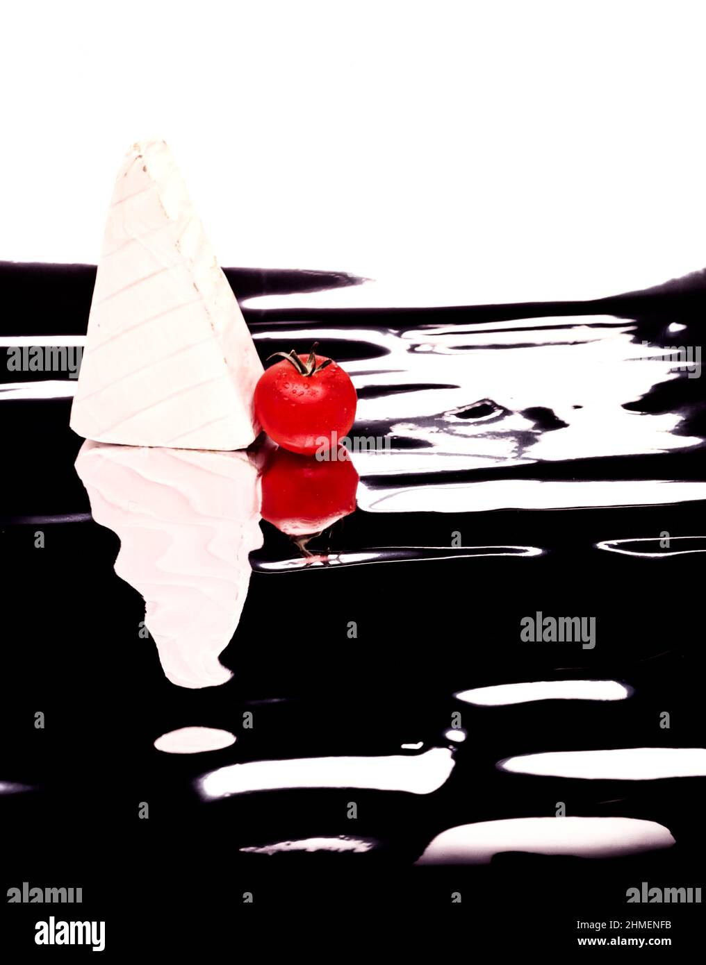 Creative snack food still-life representation of Cheese and Tomato on ...