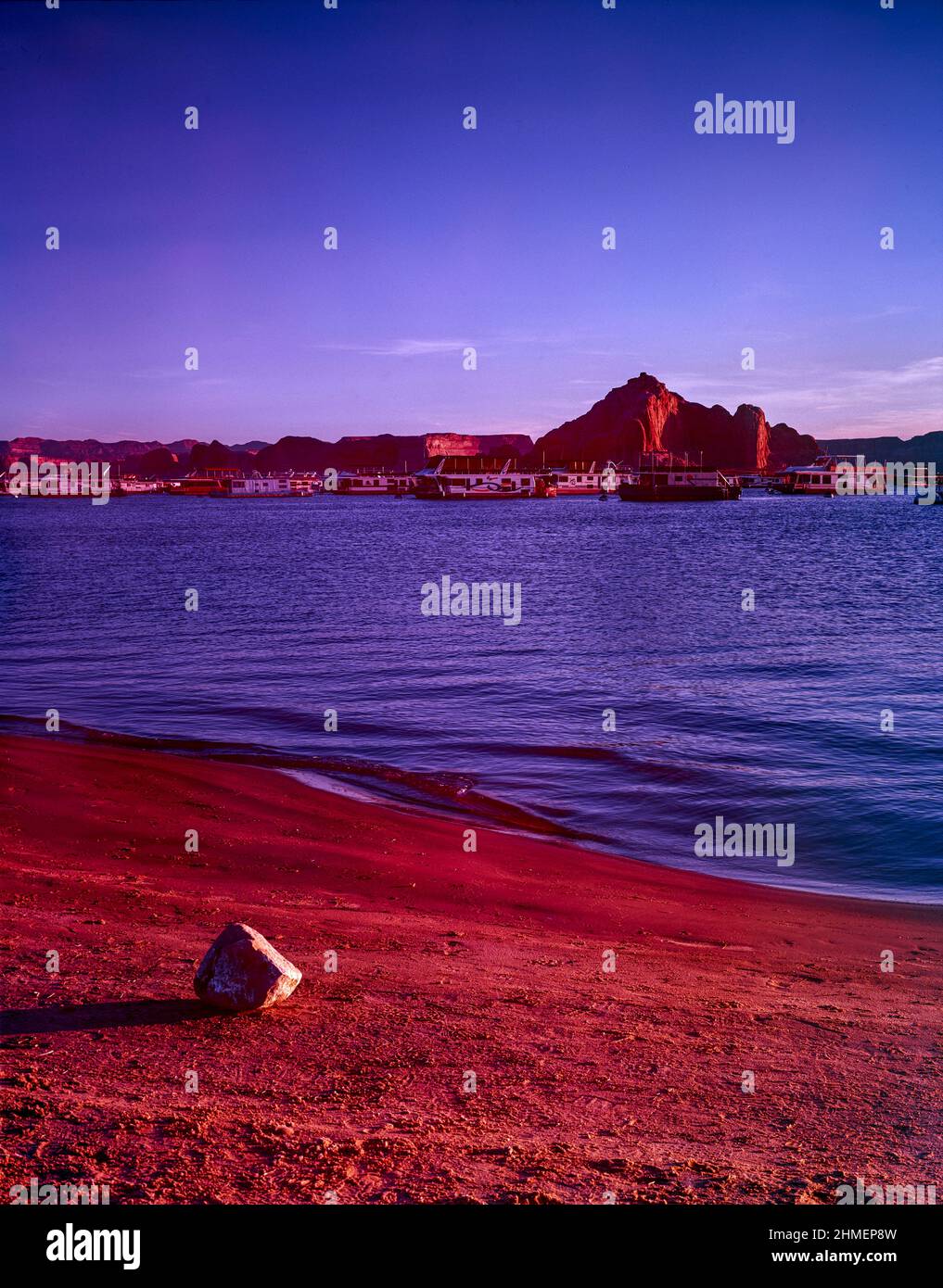 Deep natural minimalist landscape in blue with lakeside rock balanced ...