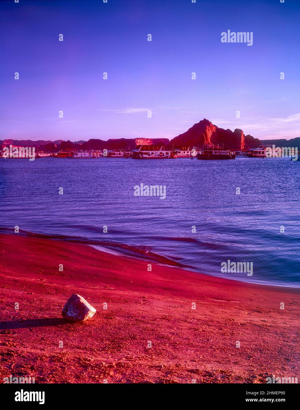 Deep natural minimalist landscape in blue with lakeside rock balanced ...