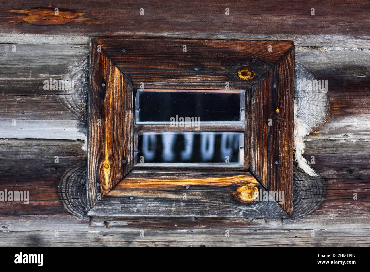 Rustic wooden house made of round logs. Ancient window design. Wooden ...