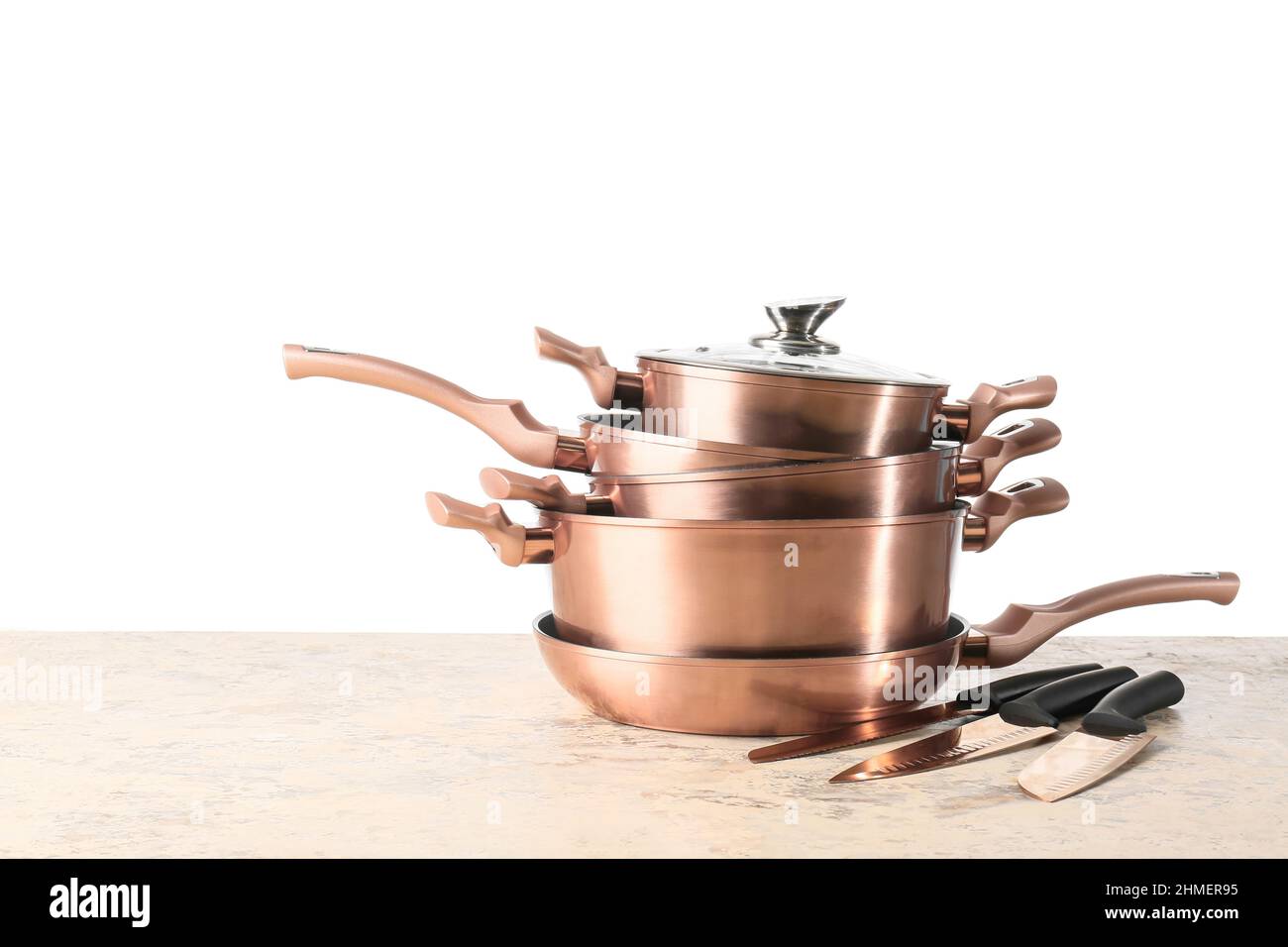 Set of copper kitchen utensils on table against white background Stock ...