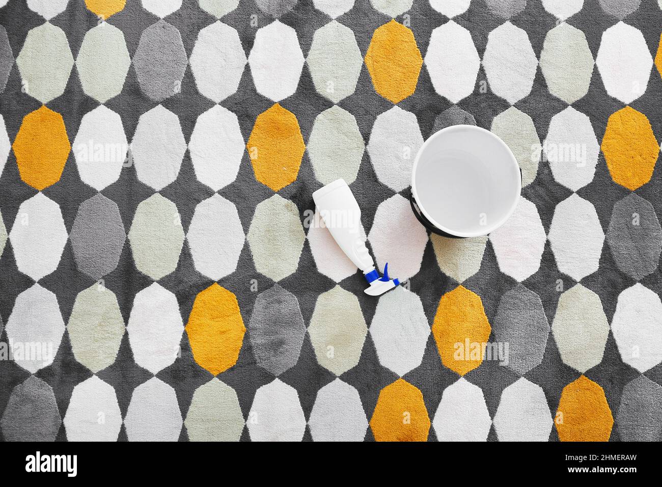 Bucket of water and detergent on colorful carpet Stock Photo - Alamy