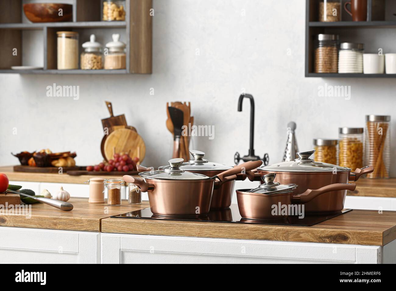 Shiny copper cooking pots on stove in kitchen Stock Photo - Alamy