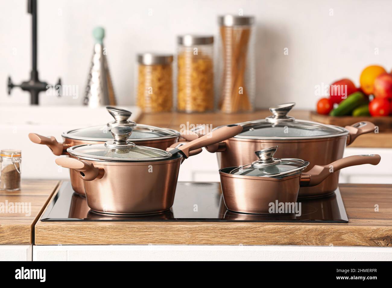 Shiny copper cooking pots on stove in kitchen Stock Photo - Alamy