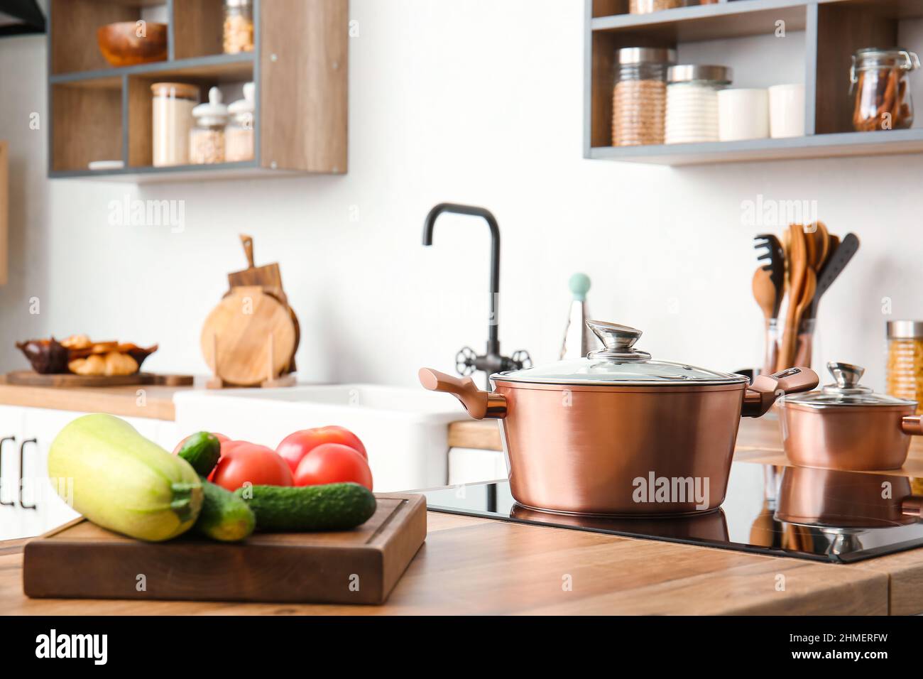 Shiny copper cooking pot on stove in kitchen Stock Photo - Alamy