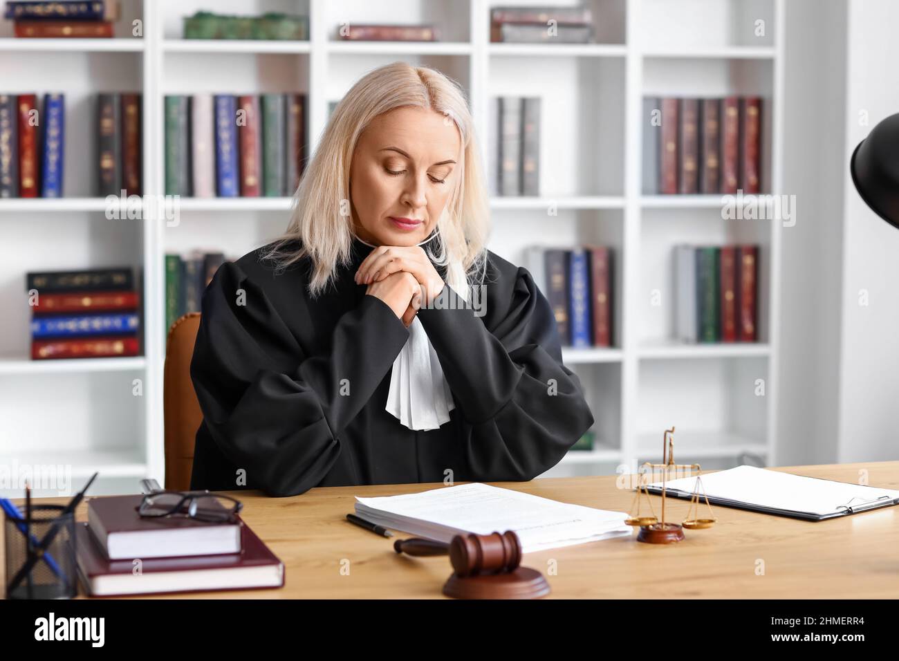 Mature female judge working at table in courtroom Stock Photo - Alamy