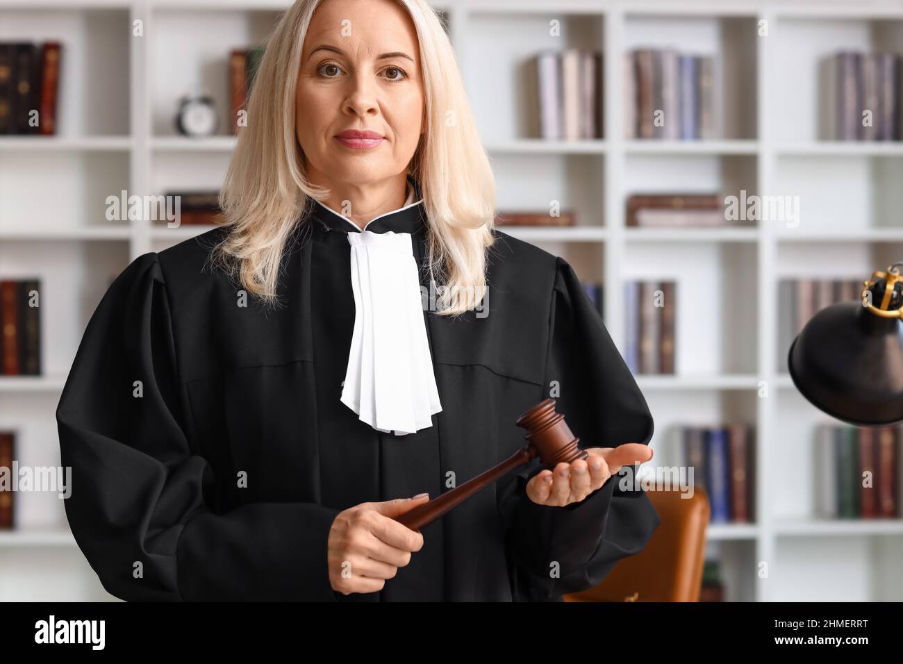 Mature female judge with gavel in courtroom Stock Photo - Alamy