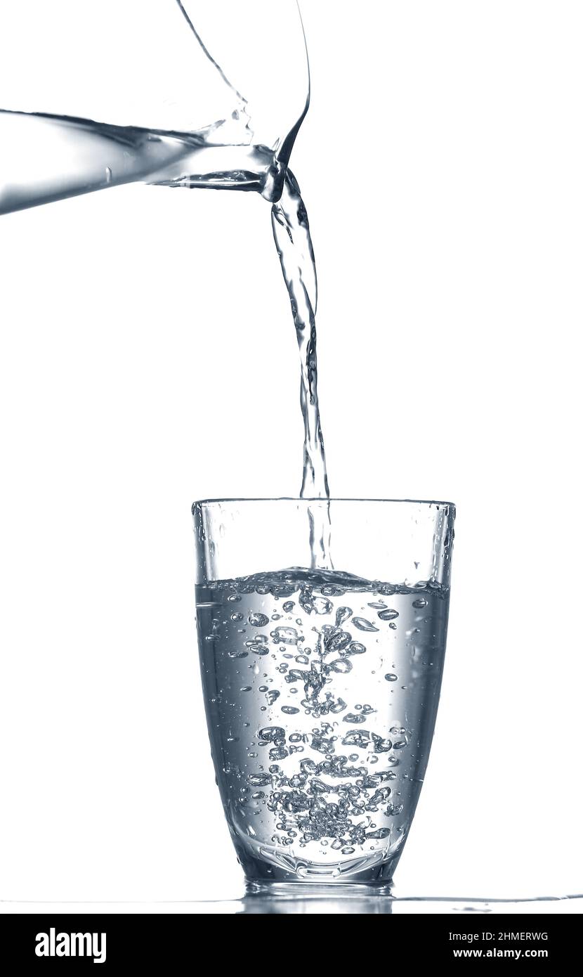 Pouring of clear water in glass isolated on white Stock Photo - Alamy