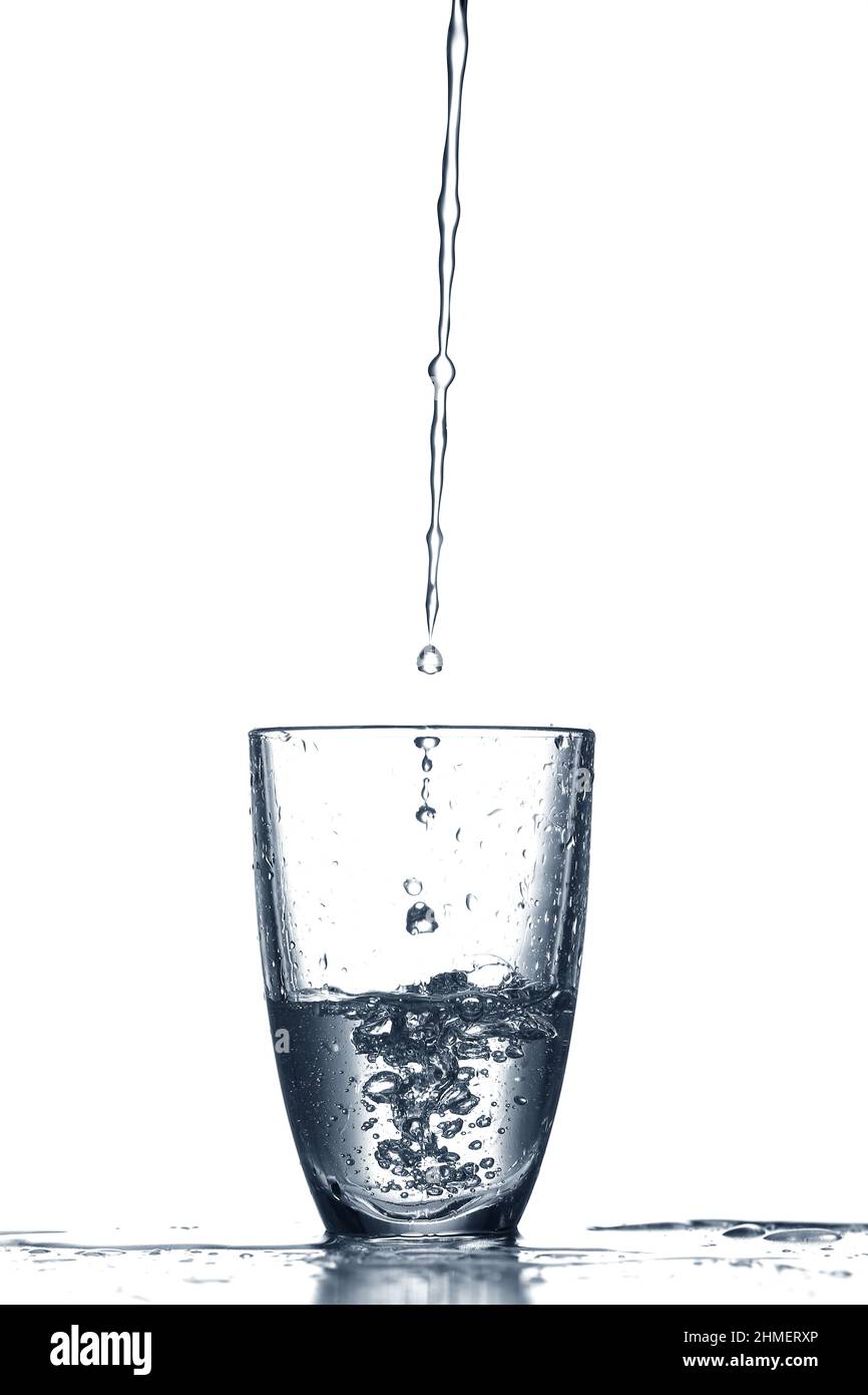 Pouring of clear water in glass isolated on white Stock Photo - Alamy