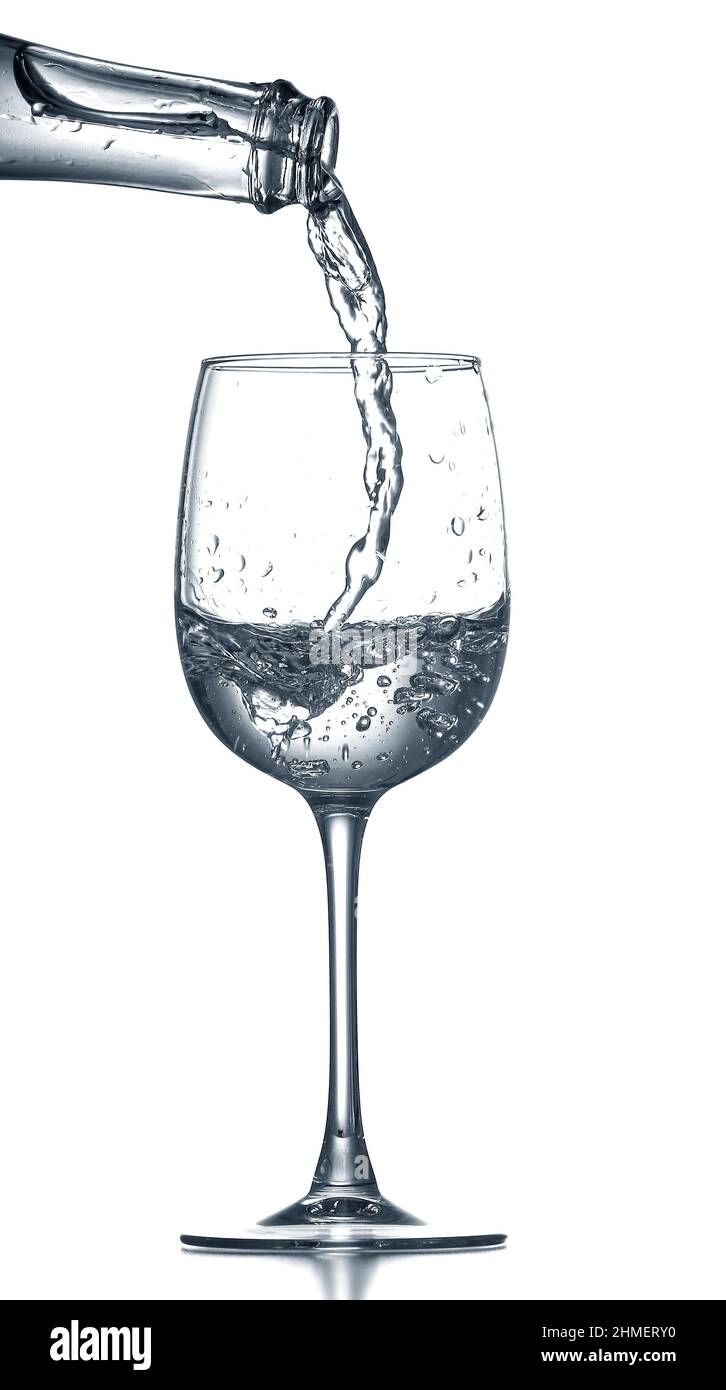 Pouring of clear water in glass isolated on white Stock Photo - Alamy