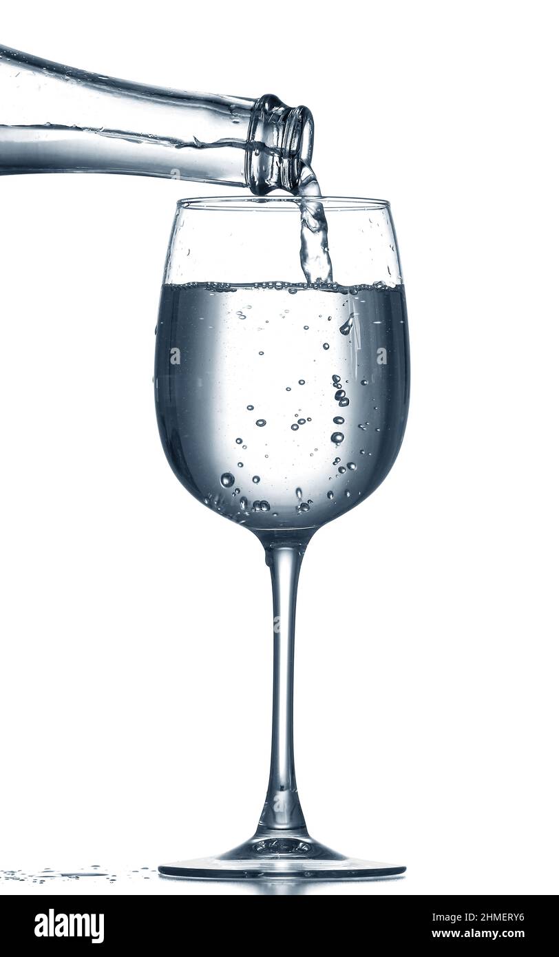 Pouring of clear water in glass isolated on white Stock Photo - Alamy