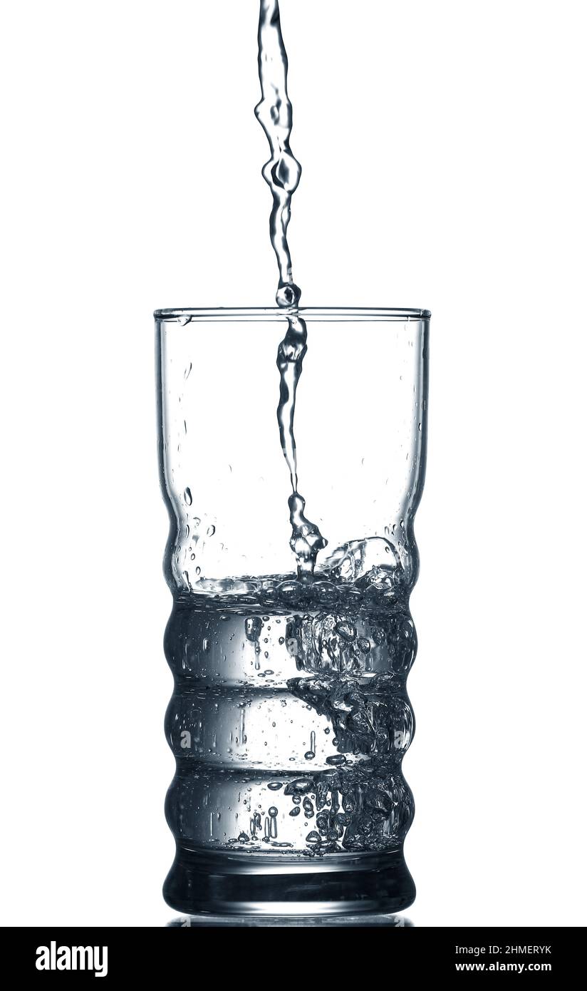 Pouring of clear water in glass isolated on white Stock Photo - Alamy