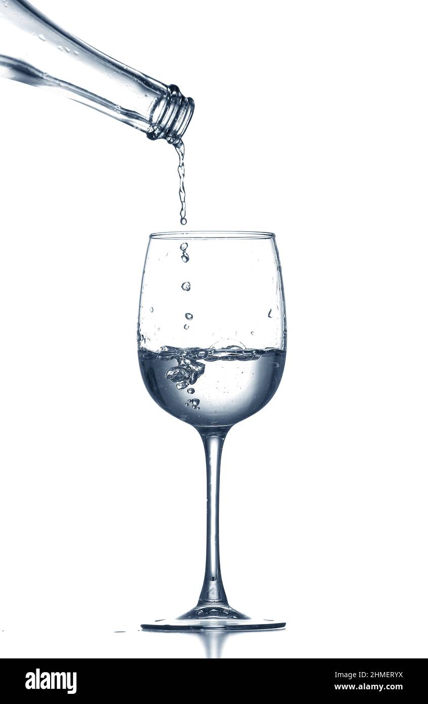 Pouring of clear water in glass isolated on white Stock Photo - Alamy