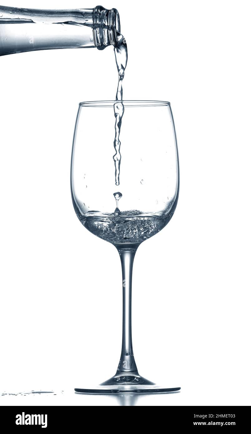 Pouring of clear water in glass isolated on white Stock Photo - Alamy