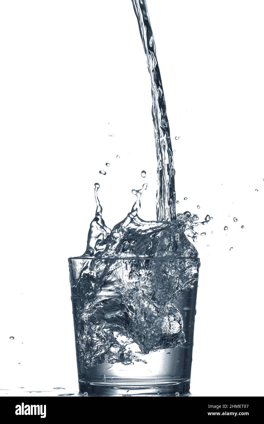 Pouring of clear water in glass isolated on white Stock Photo - Alamy