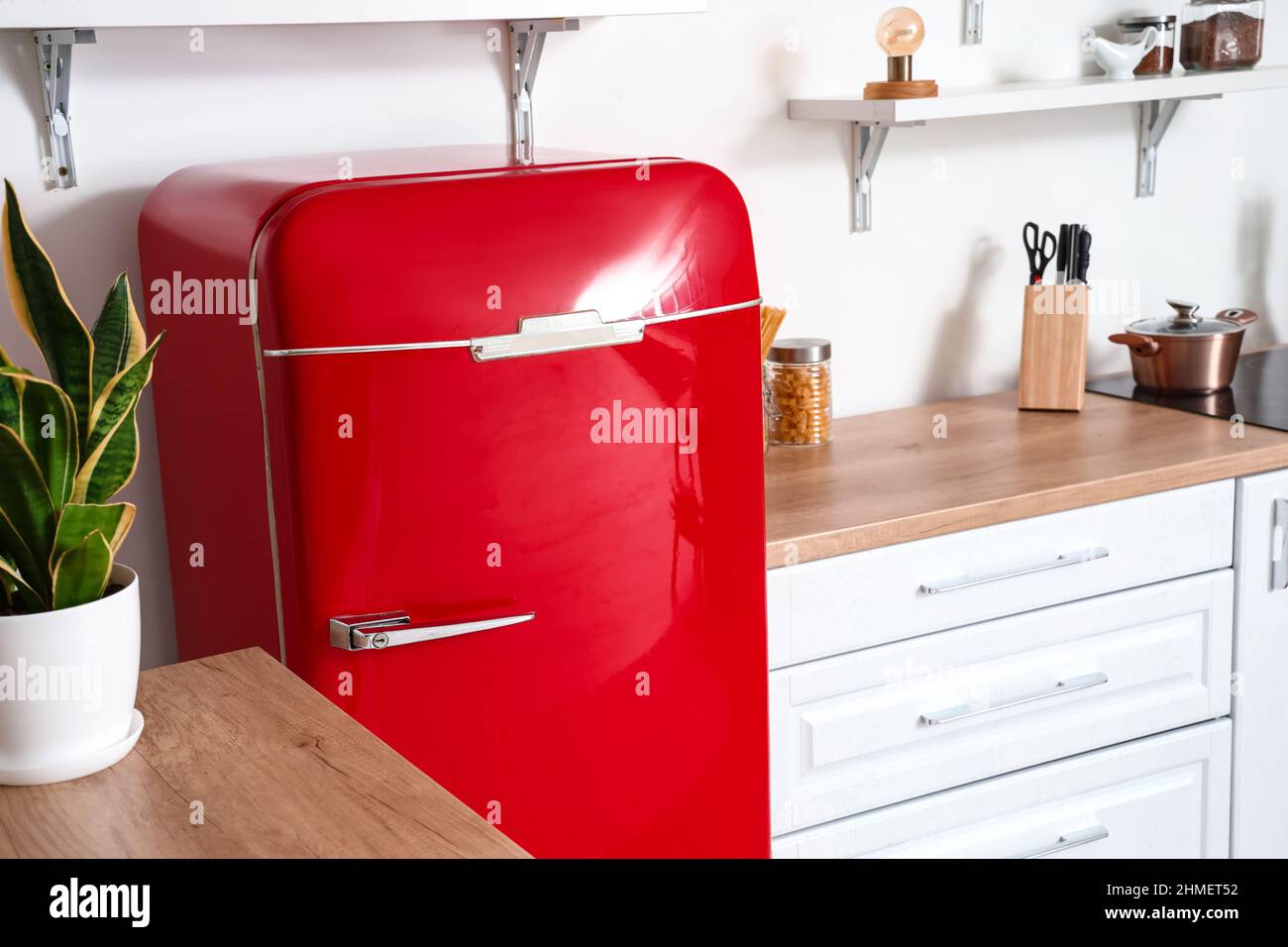 Stylish red fridge near light wall in kitchen Stock Photo - Alamy
