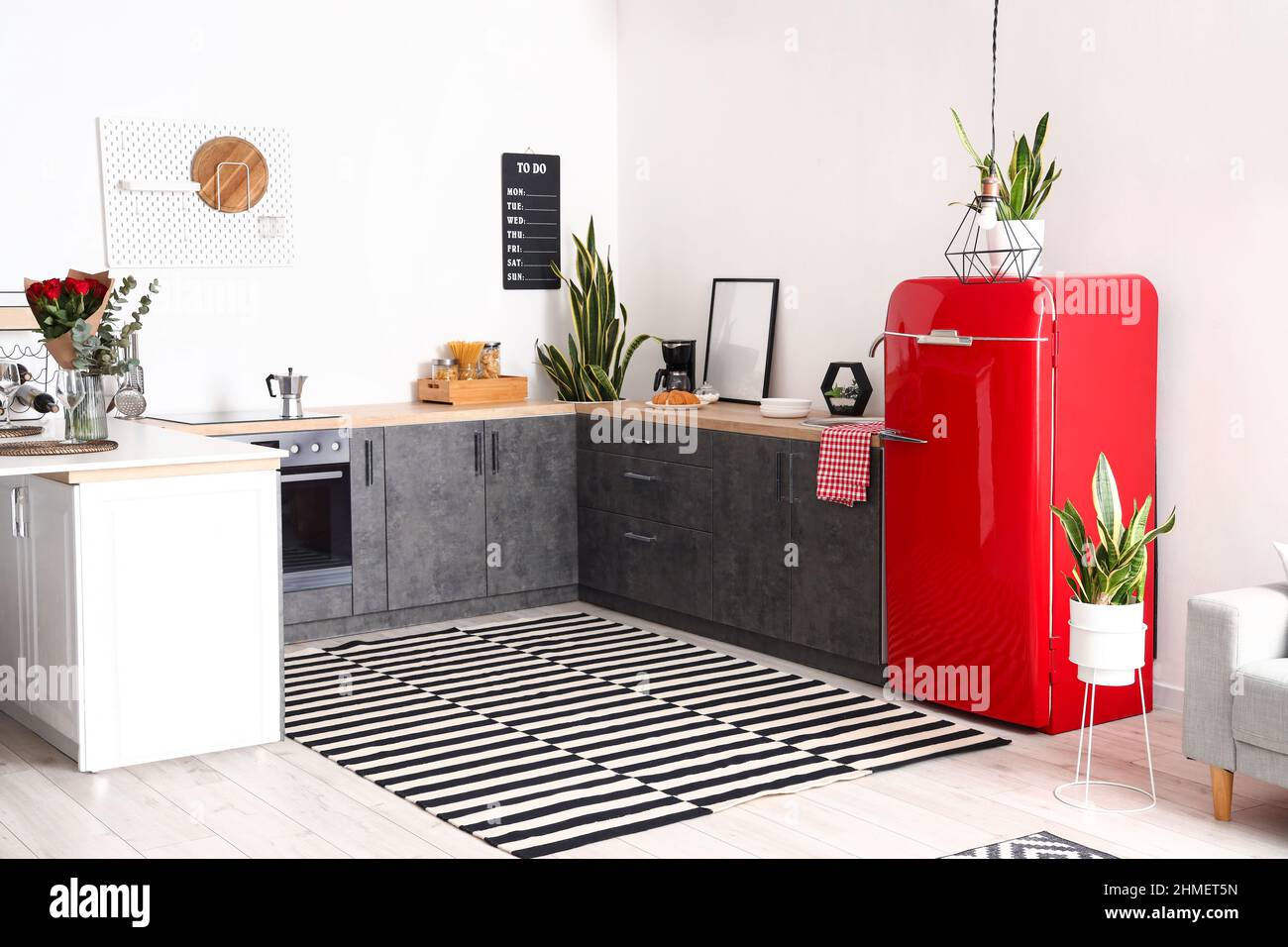 Interior of modern kitchen with counters and red fridge Stock Photo - Alamy