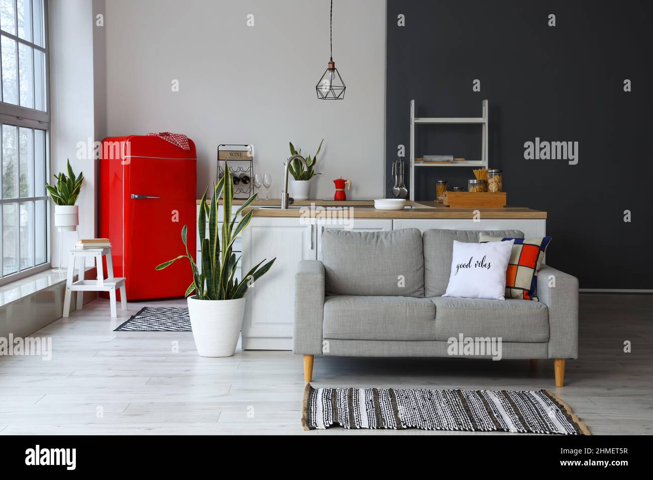 Interior of modern kitchen with red fridge, counters and sofa Stock ...