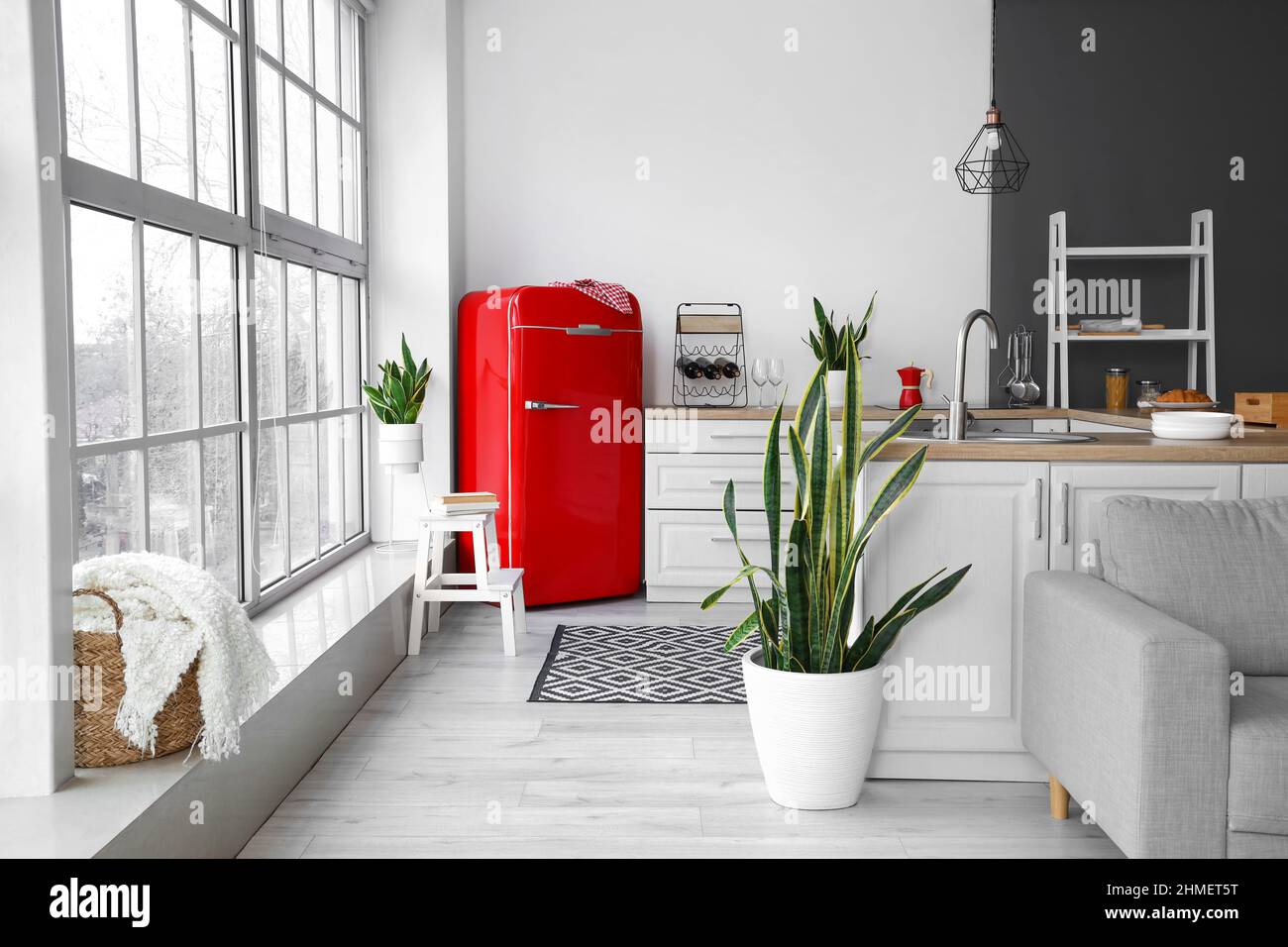 Interior of modern kitchen with red fridge and white counters Stock ...