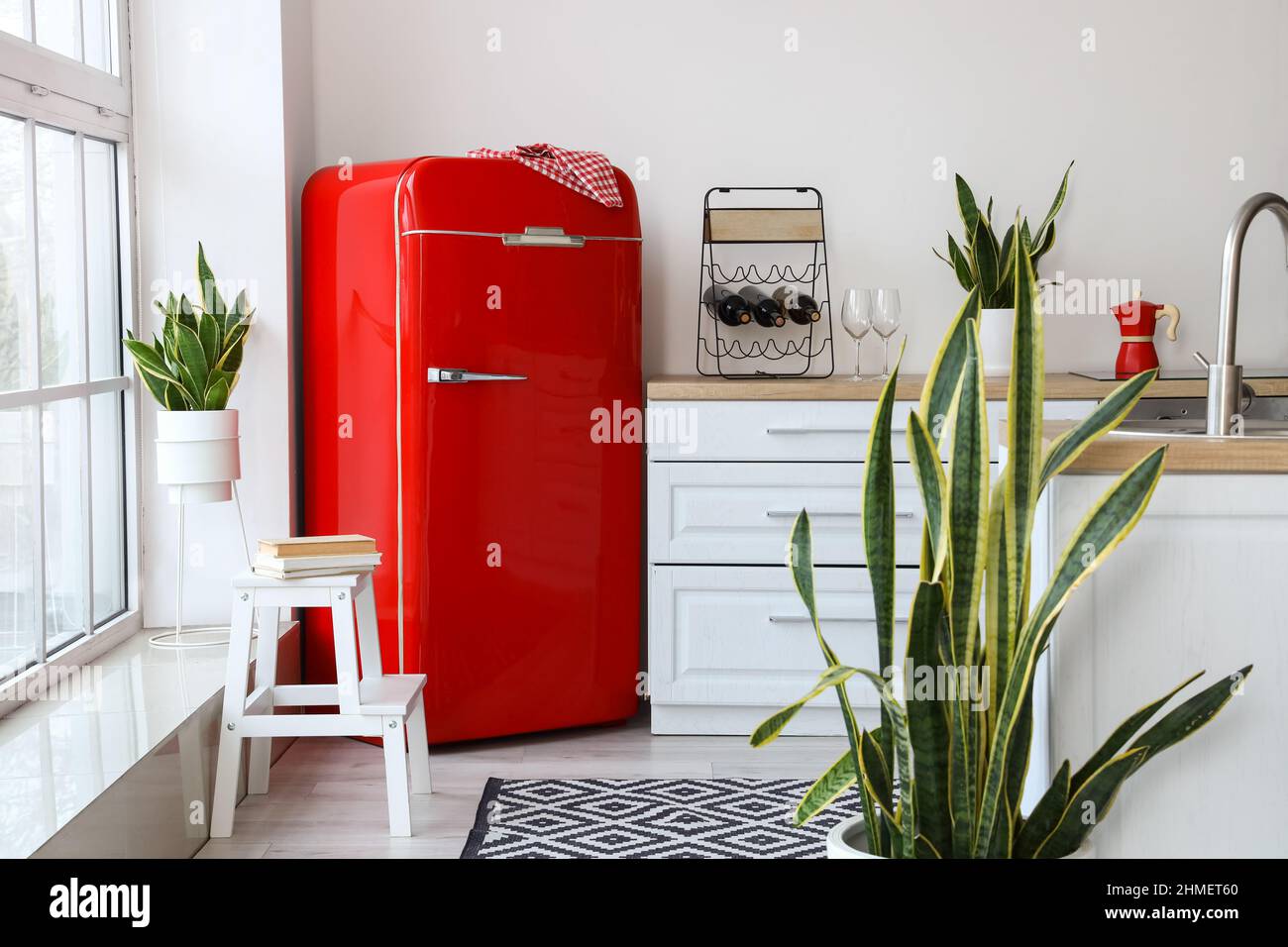 Interior of modern kitchen with red fridge and white counters Stock ...