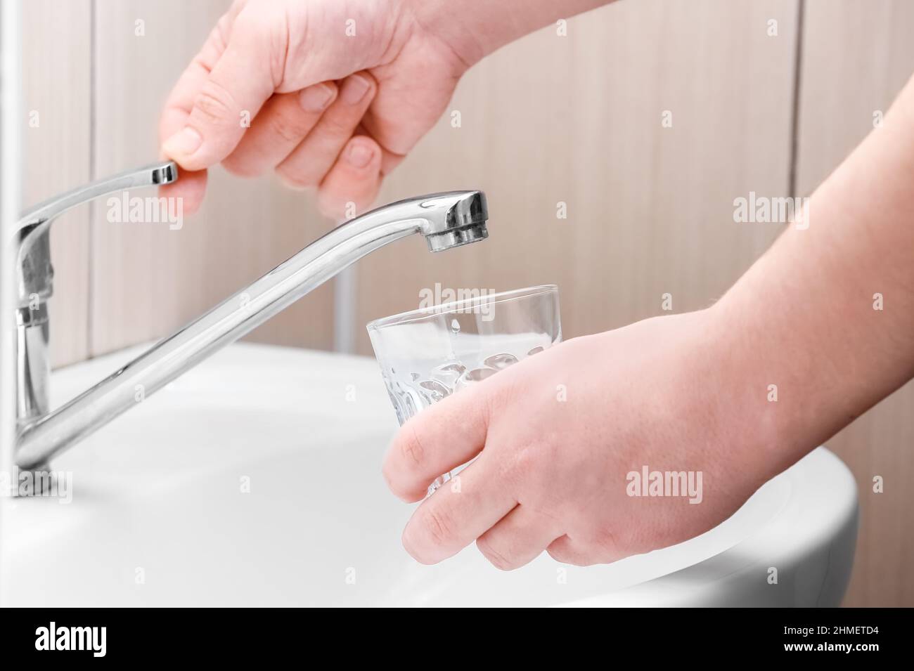 Man turning on bath tap hi-res stock photography and images - Alamy