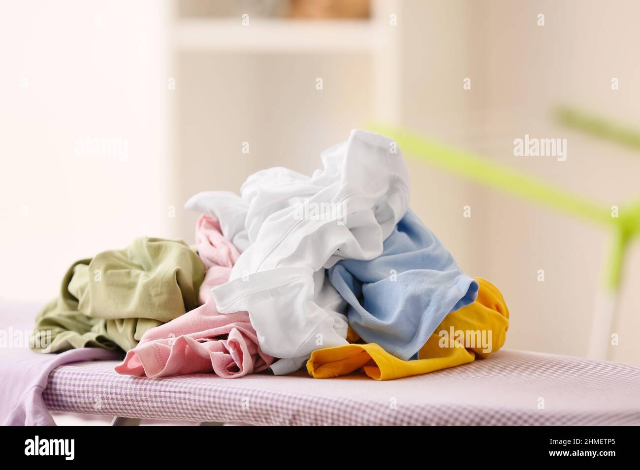 Crumpled clothes on ironing board Stock Photo - Alamy