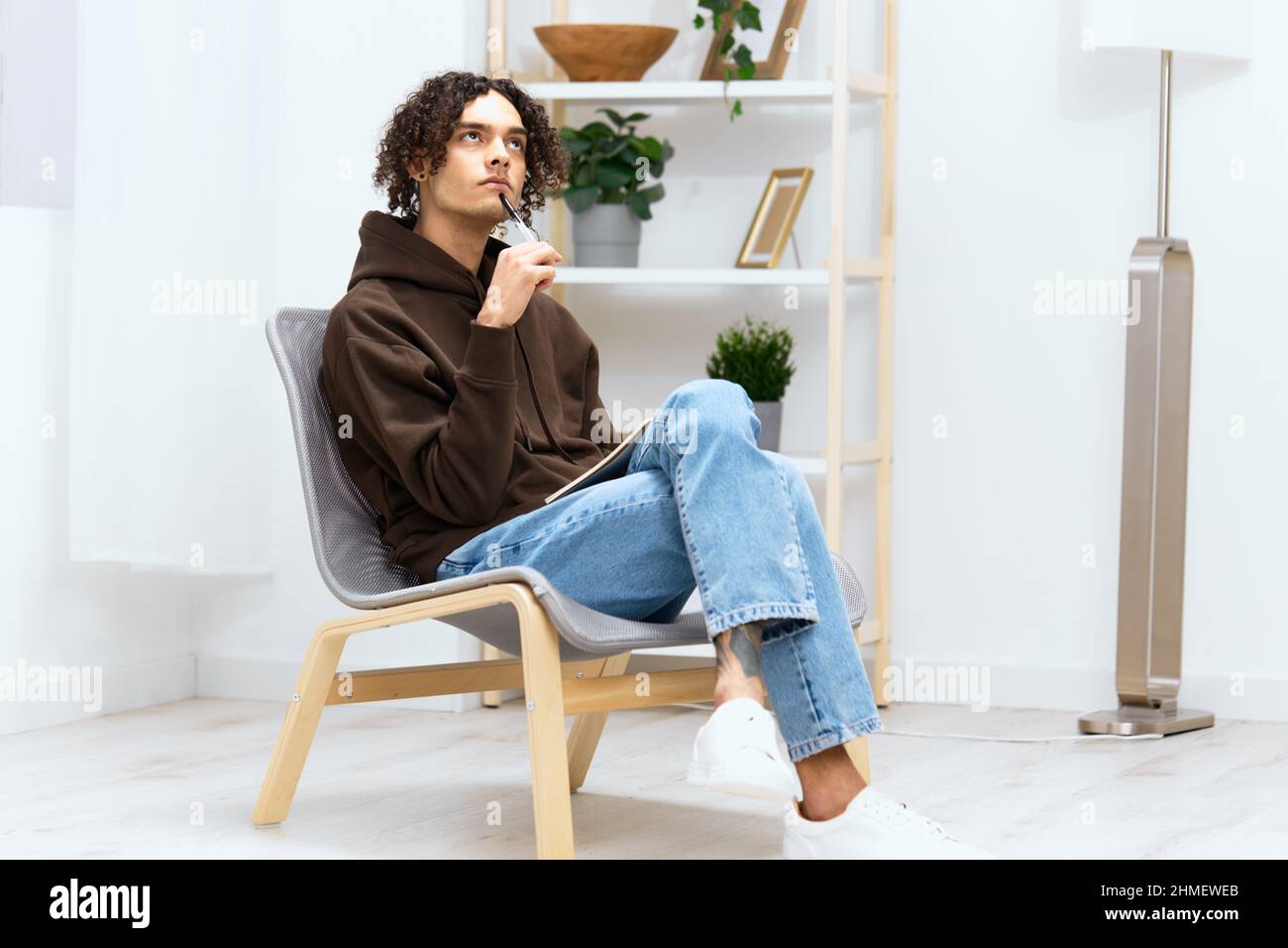 handsome guy writing down ideas with a notepad light background Stock ...