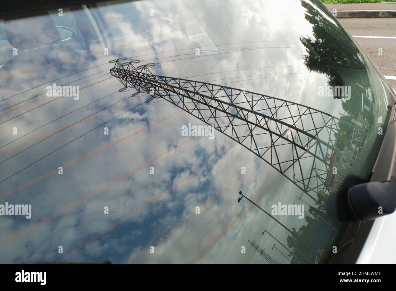 Pillar and High Voltage Electric Cables Reflected in the Rear Window of ...