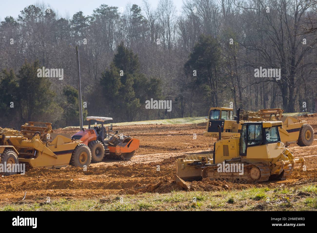 Excavator doing moving soil construction works landscaping works for ...