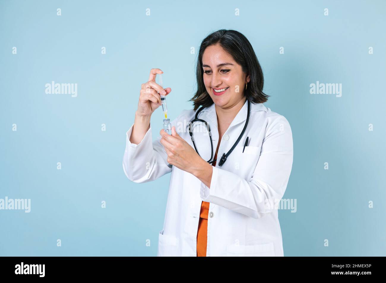 latin woman doctor holding vaccine injection in Mexico latin America ...