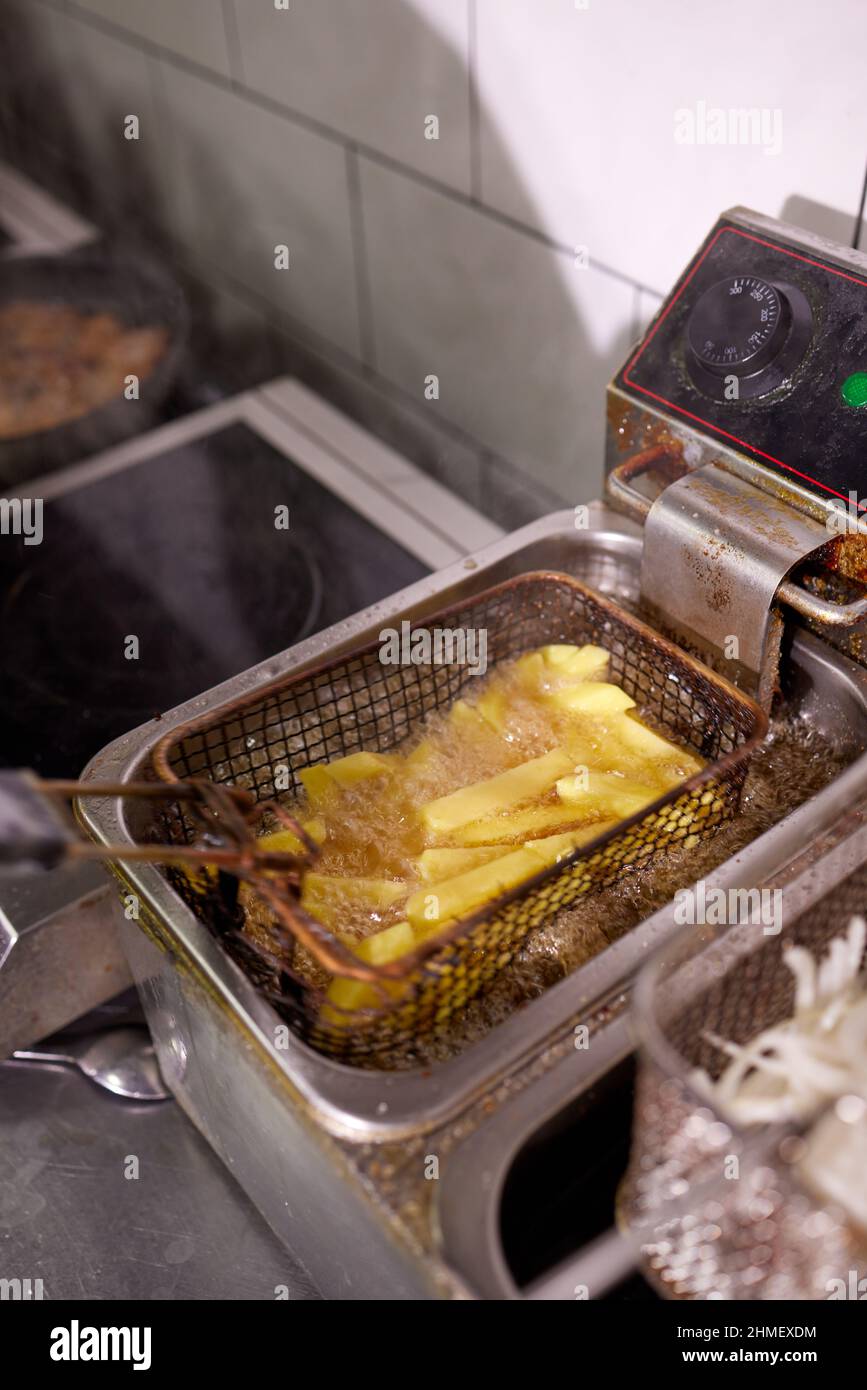 Dirty cooking area with french fries deep fryer Stock Photo - Alamy