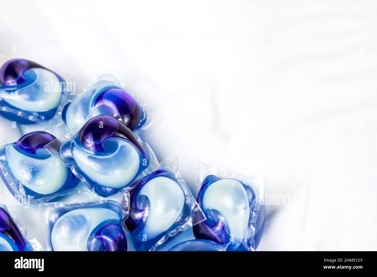 Bright blue washing pods and capsules with liquid detergent for machine ...