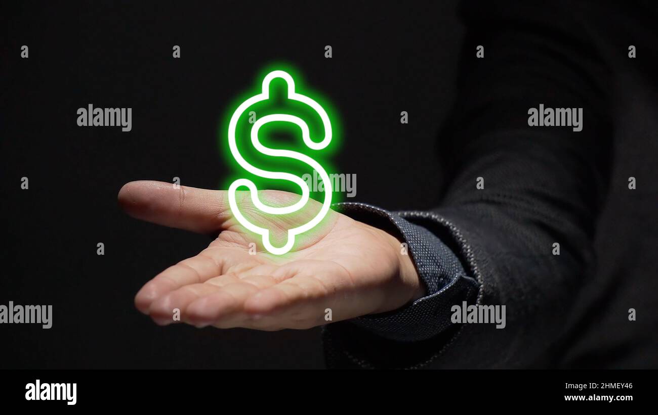 Close-up shot of a businessman holding a 3D rendered dollar sign ...