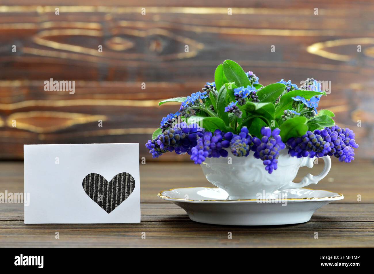 Floral greeting card with muscari flowers in vintage cup on wooden ...