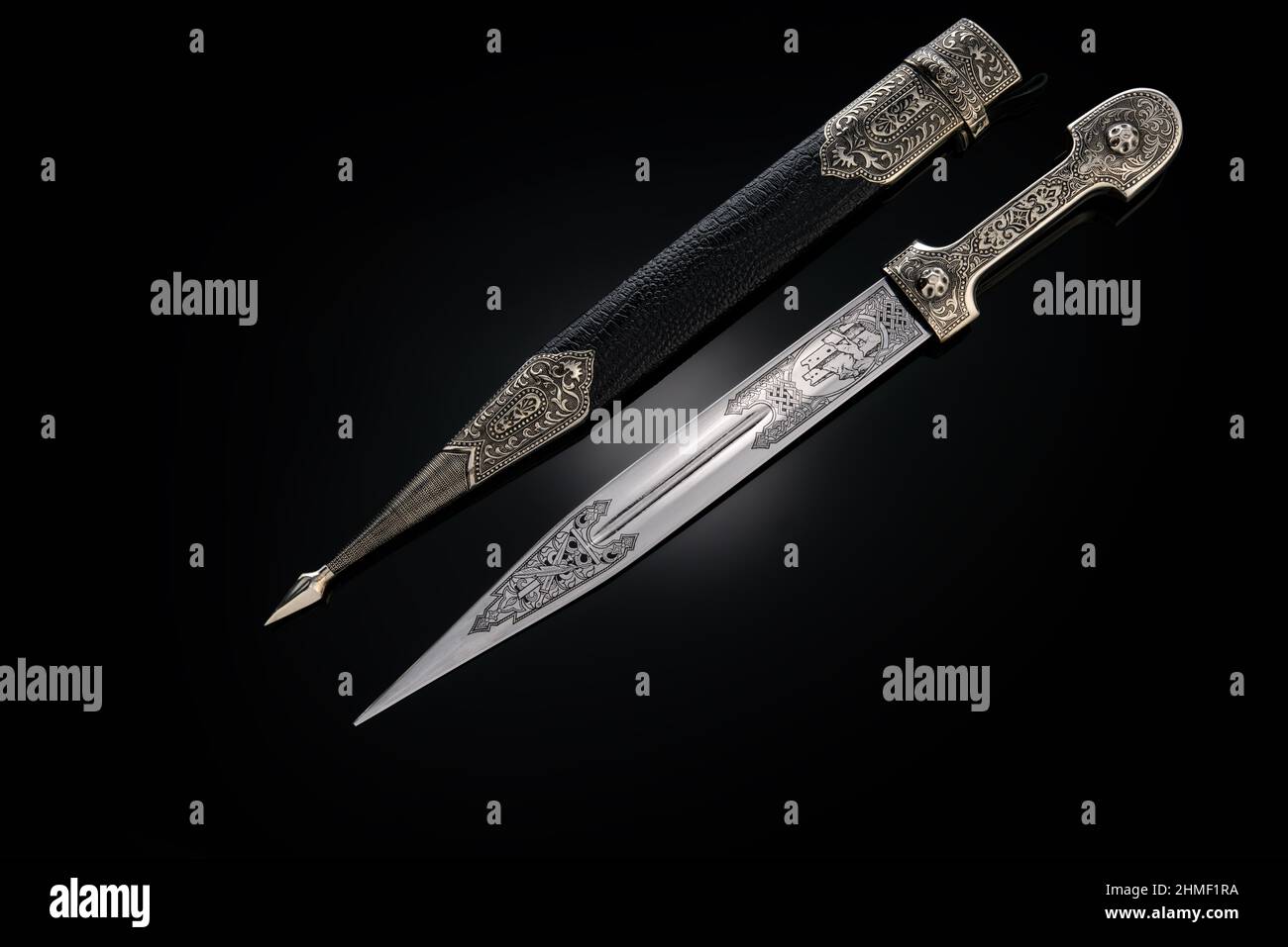 souvenir collectible silver dagger with scabbard on black. Luxury ...