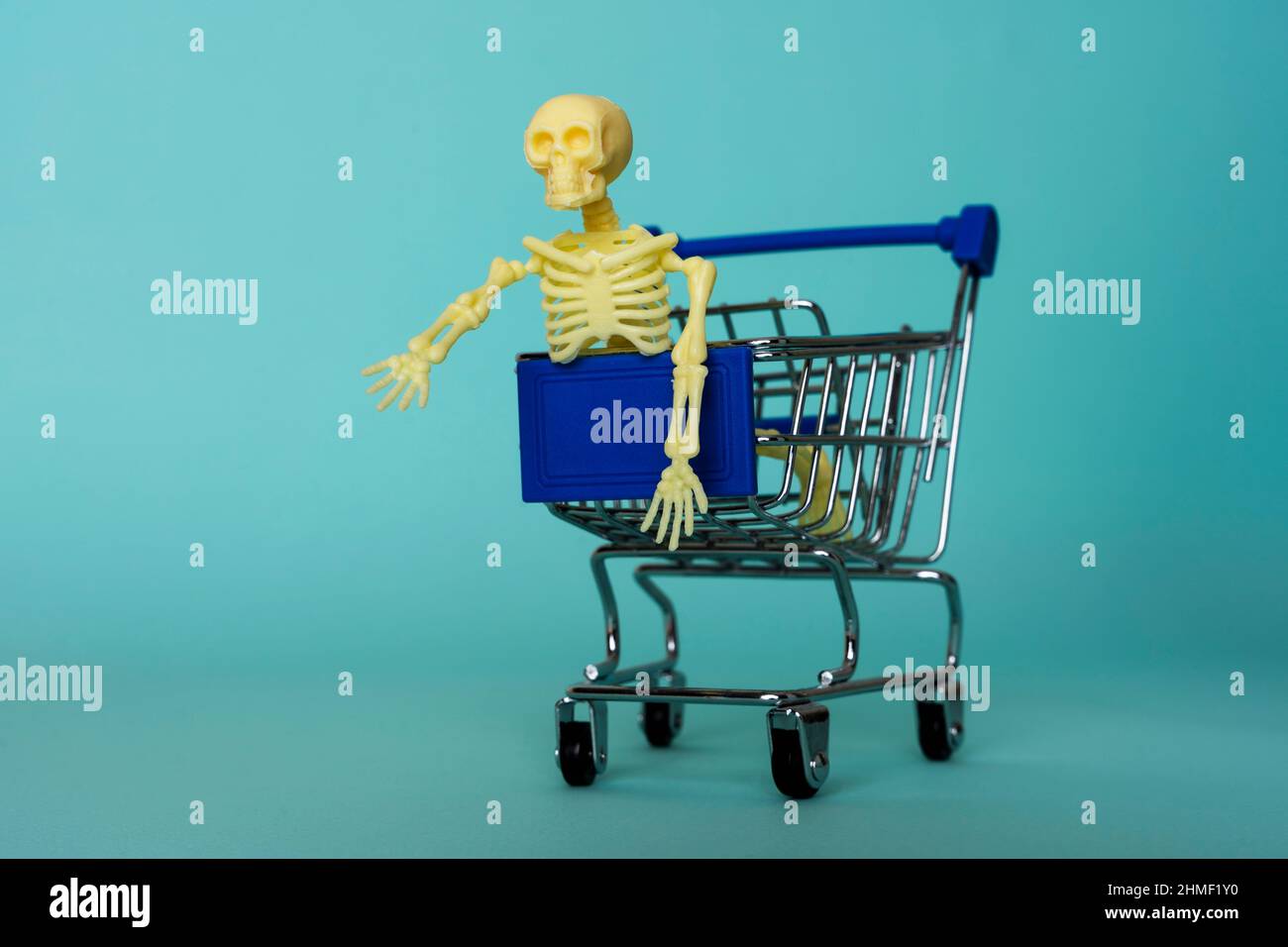 creative minimalist composition, a skeleton riding on a supermarket ...