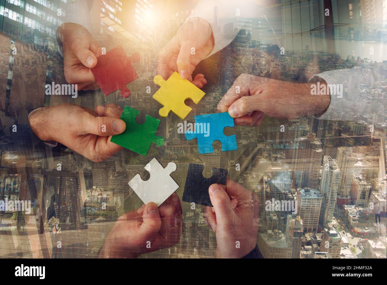 Teamwork of partners connect puzzle pieces as integration and startup ...