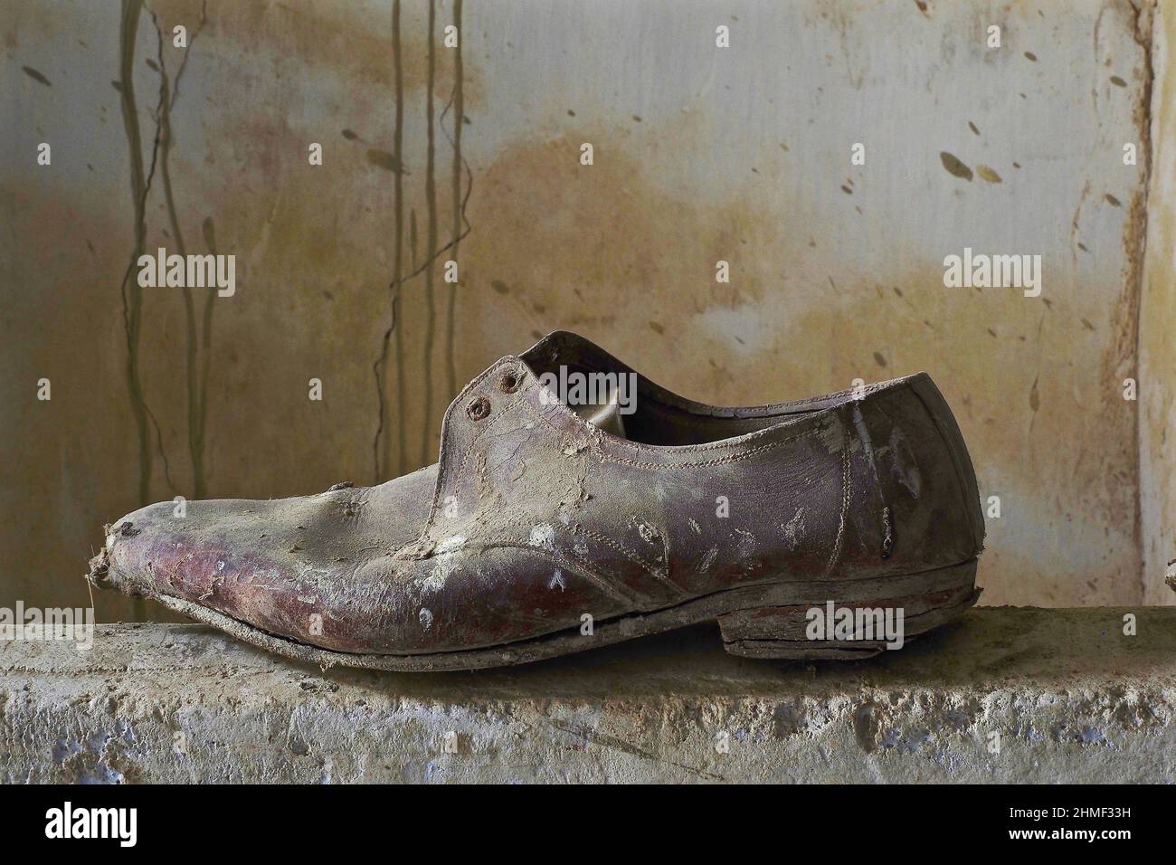 Men's low shoe on wall, dilapidated leather shoe standing on wall ...