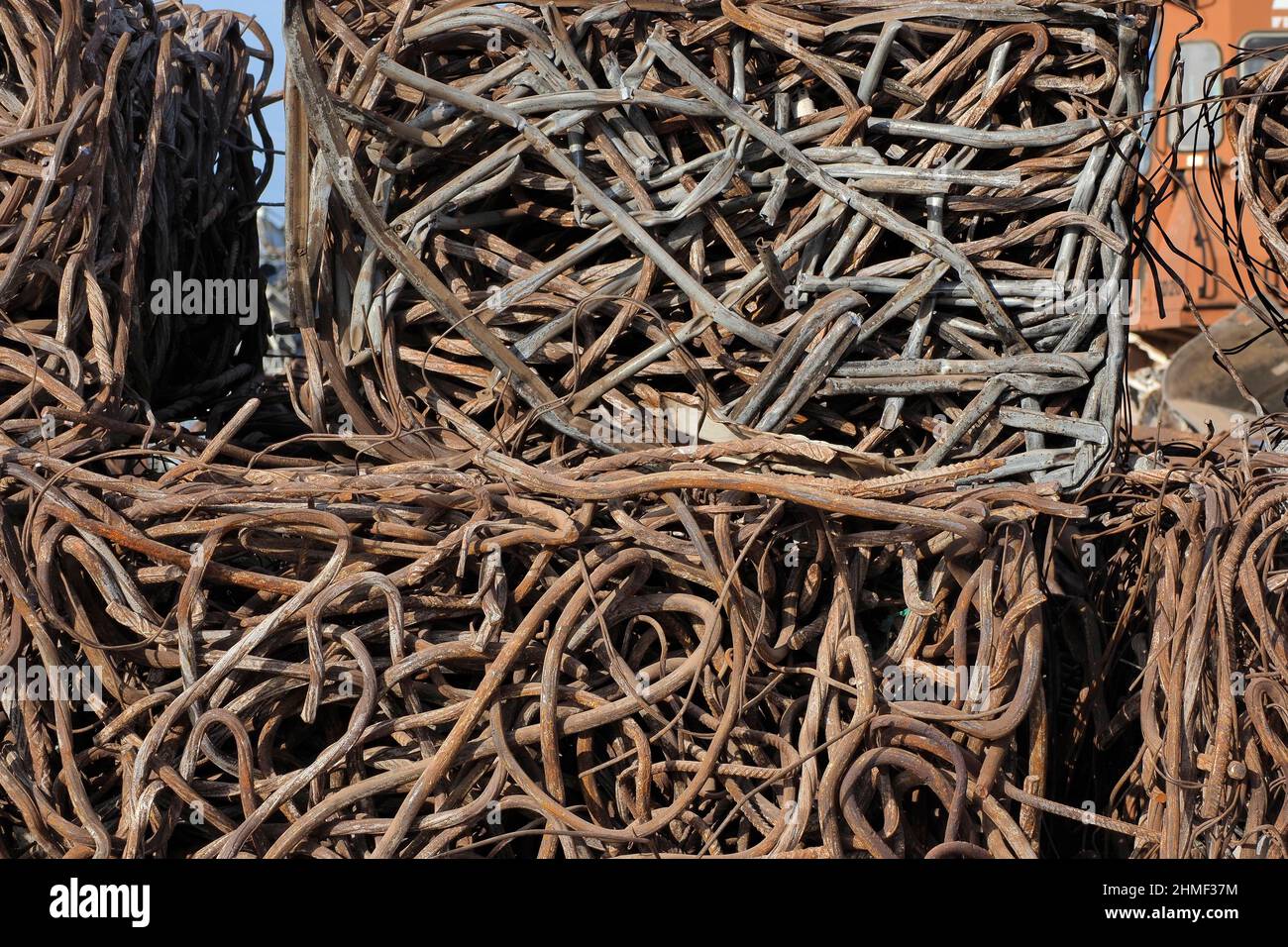 Crushed iron grids in the cube, scrap pile with metal, aluminium waste ...