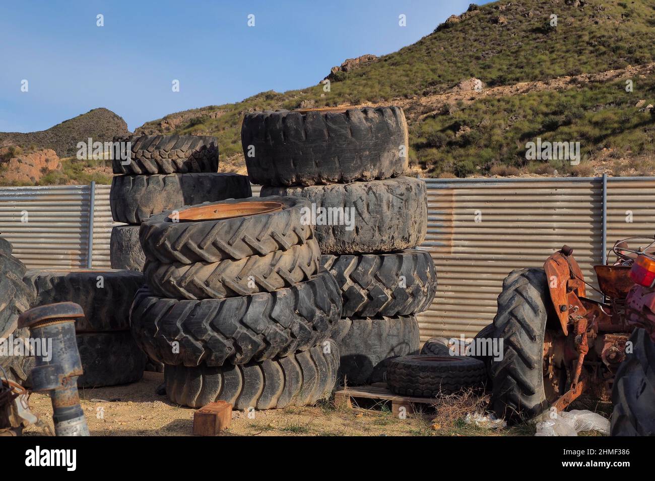 Stacked tyres from agricultural machinery and tractors in scrap yards ...