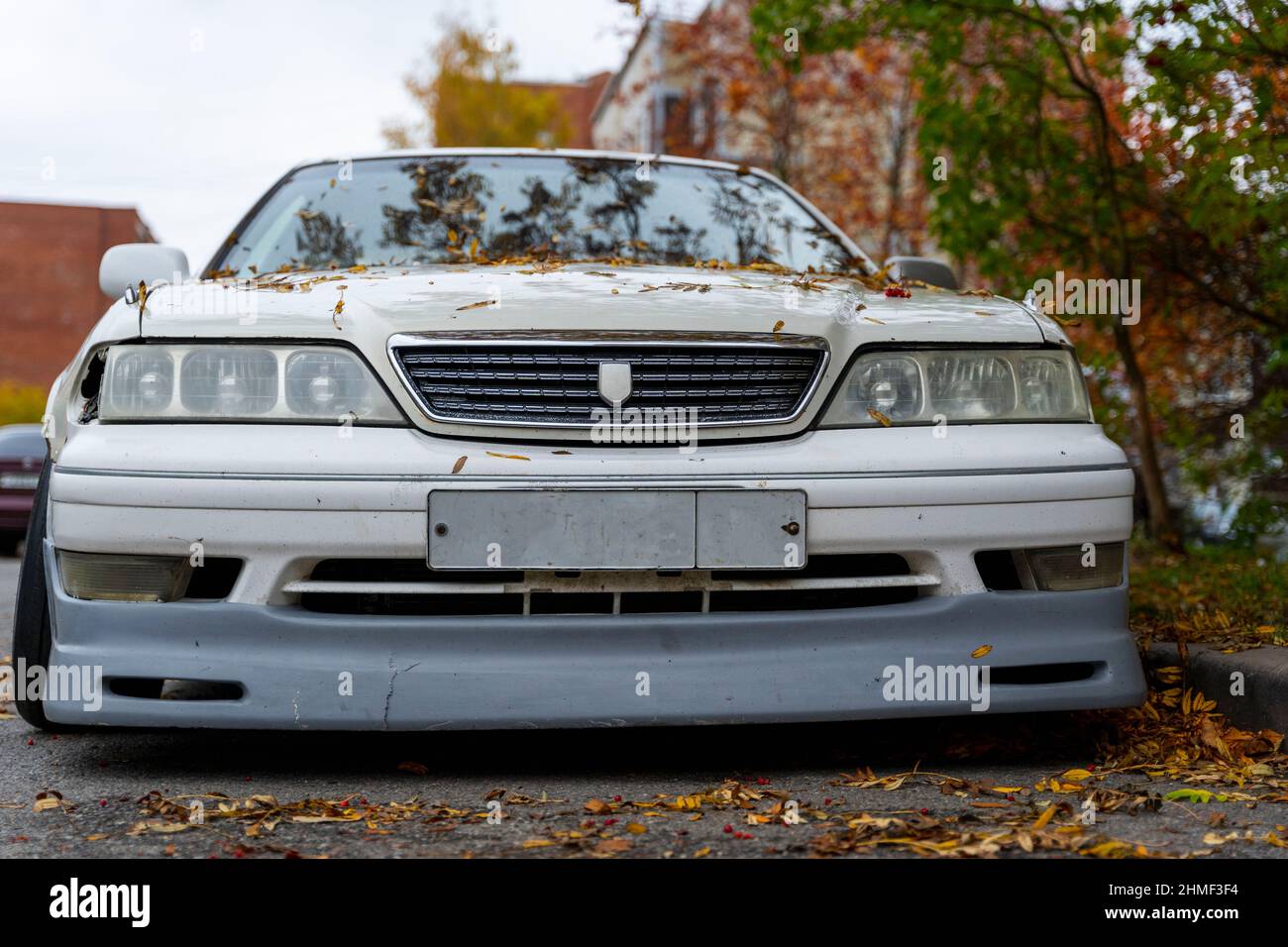 An old classic Japanese car in an autumn urban landscape, a popular ...
