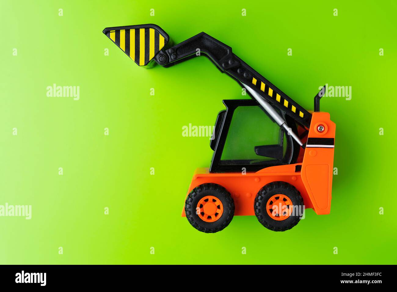 Orange Toy Loader on Green background, Mini Loader, Toy Industrial Car ...