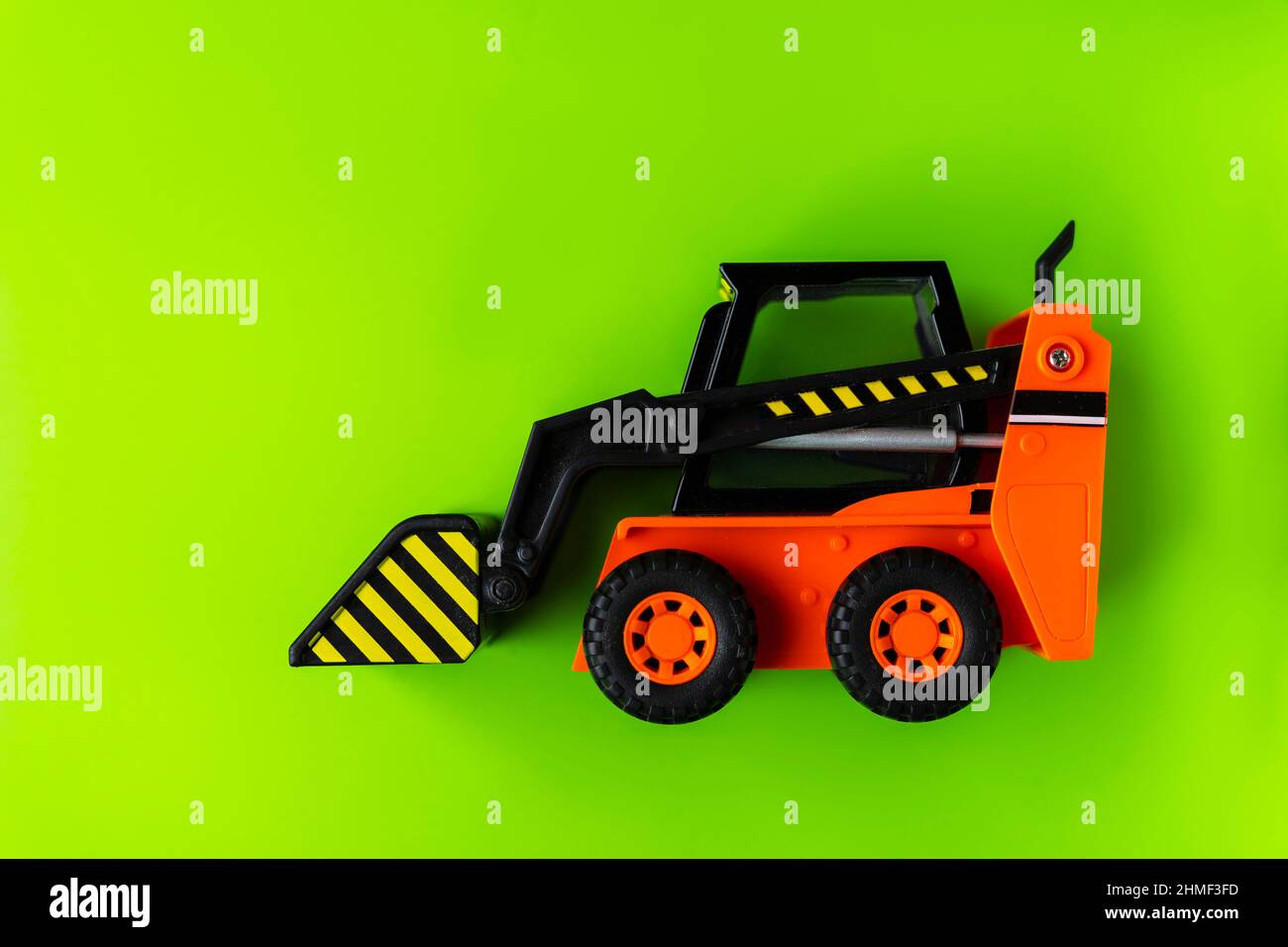 Orange Toy Loader on Green background, Mini Loader, Toy Industrial Car ...