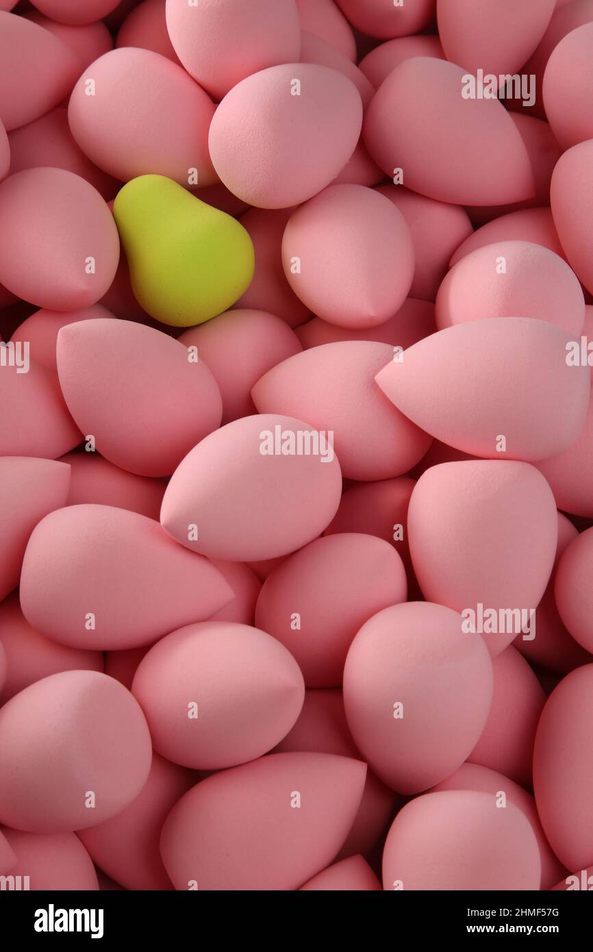 beauty background a bunch of pink gentle sponges and one contrast green ...