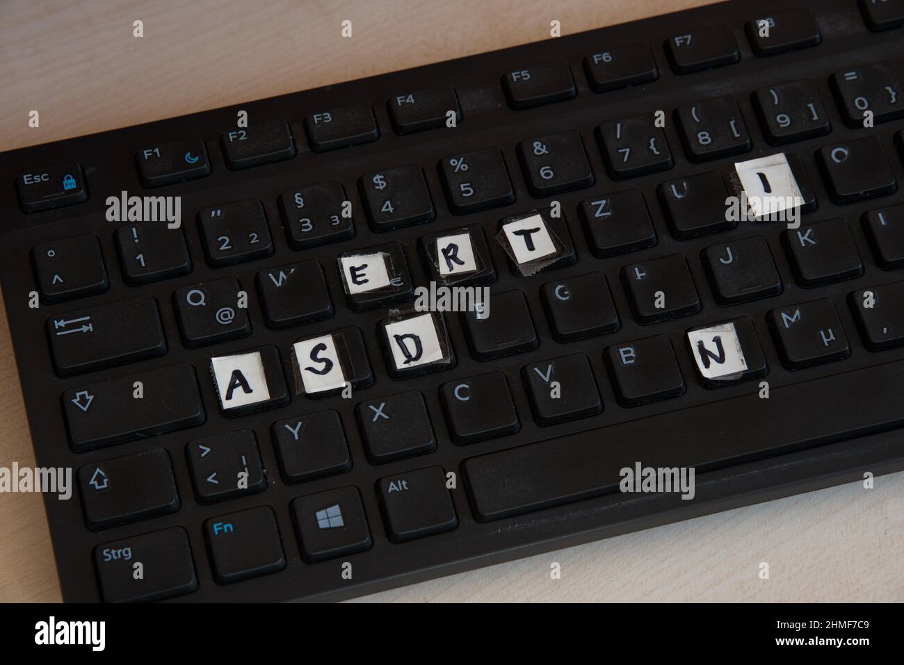A computer keyboard with keys covered in letters Stock Photo - Alamy