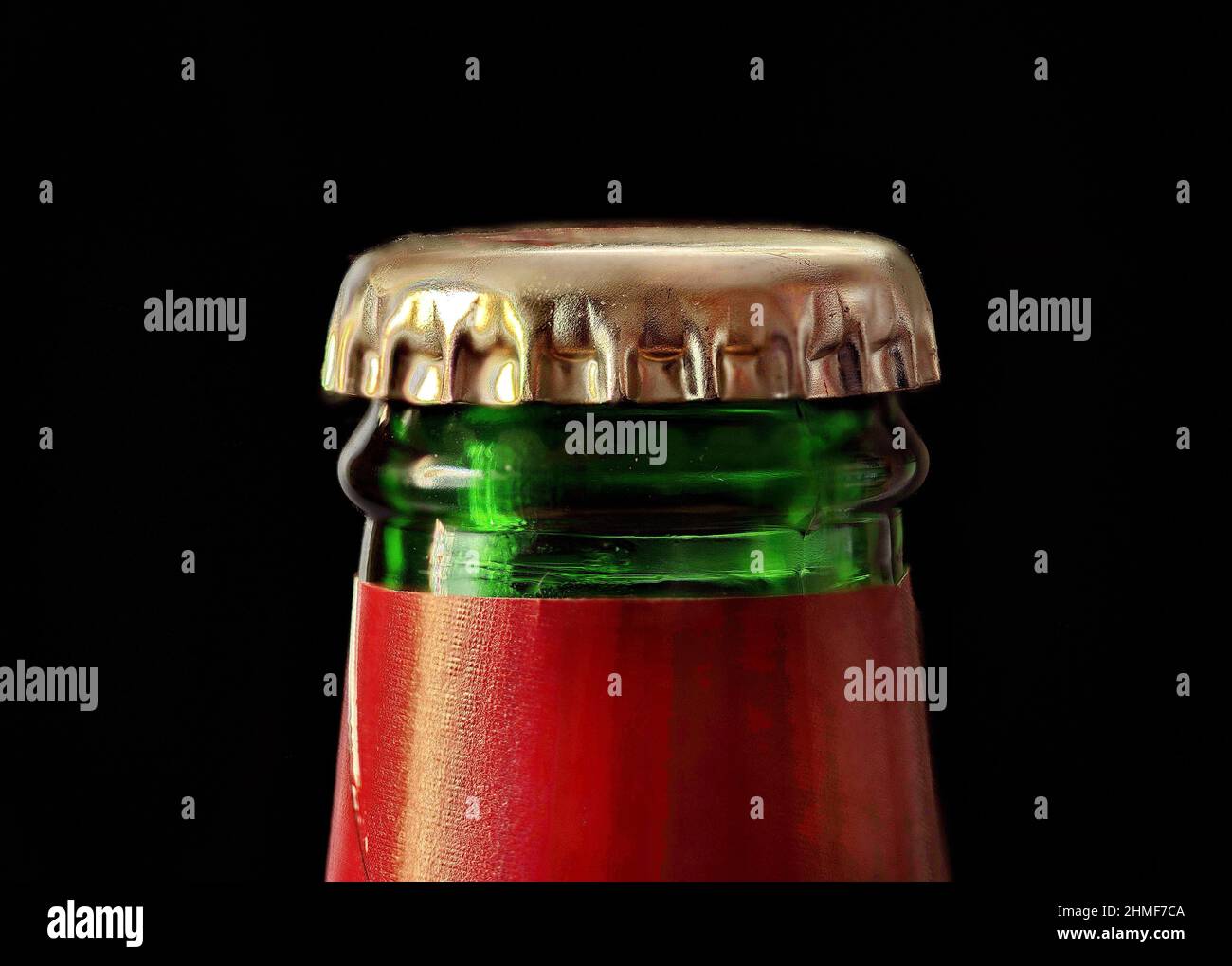 Green beer bottle with gold coloured crown cork Stock Photo - Alamy