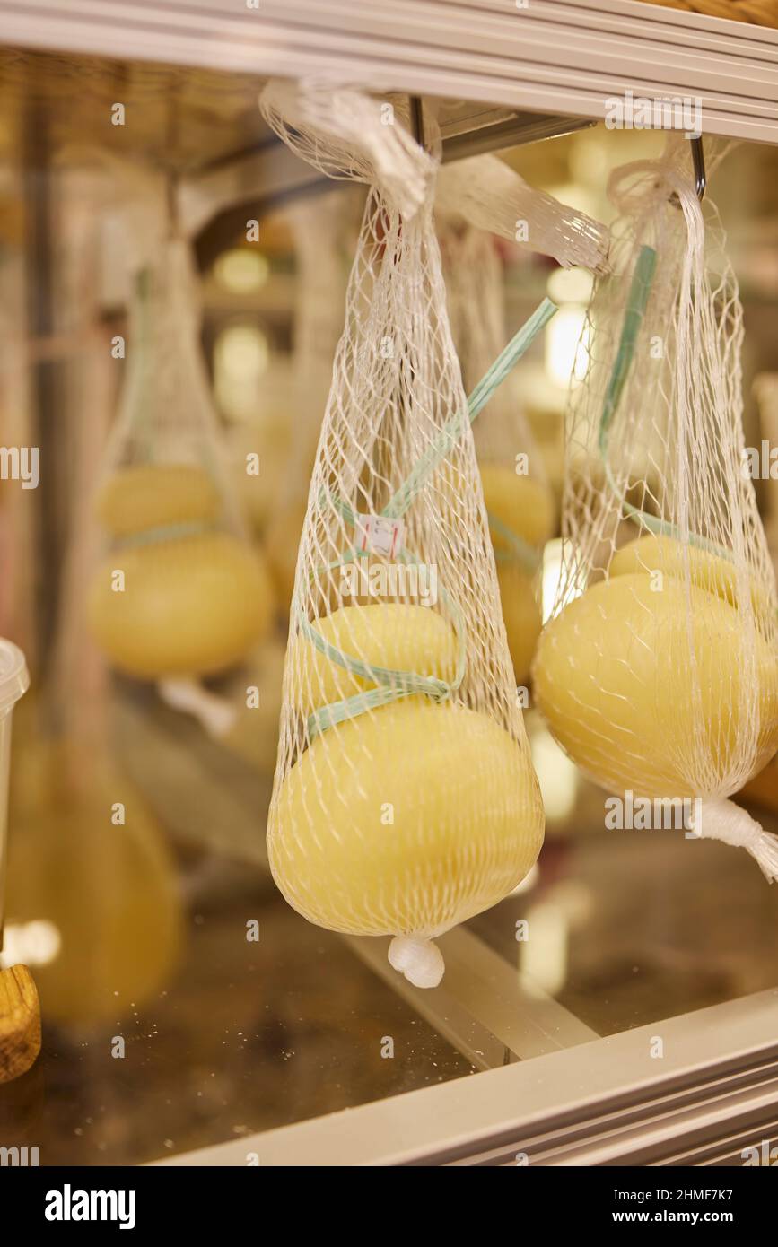Delicious fresh Caciocavallo and Scamorza cheese hanging. Italian ...